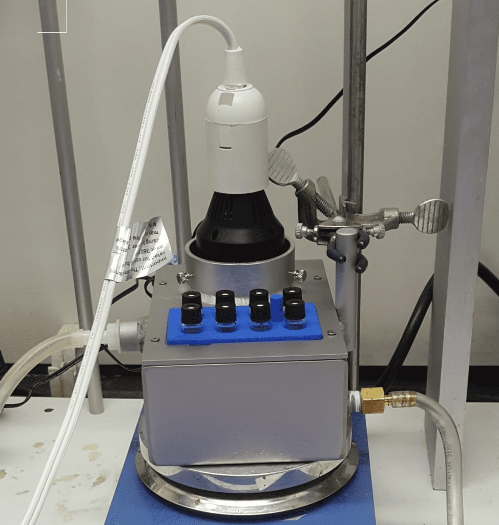 Laboratory equipment with light bulb and vials. - HepatoChem